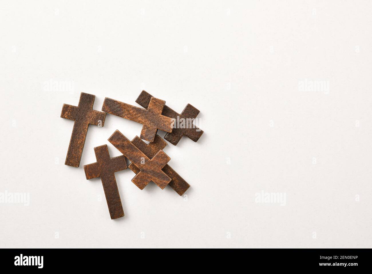 Background with lots of wooden dark brown christian crosses on white ...