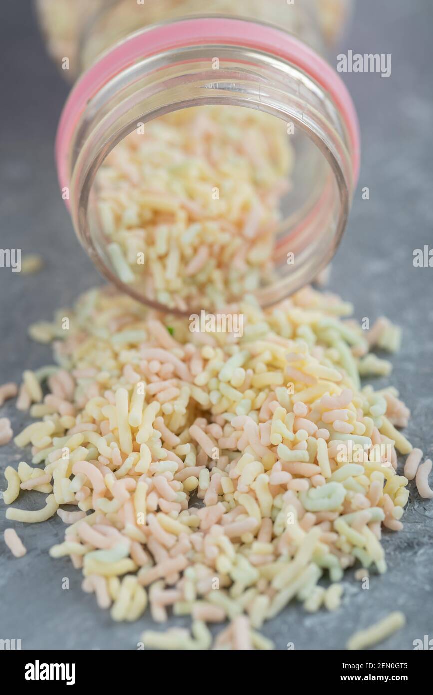 Pile of colorful sprinkles out of plastic bottle Stock Photo - Alamy