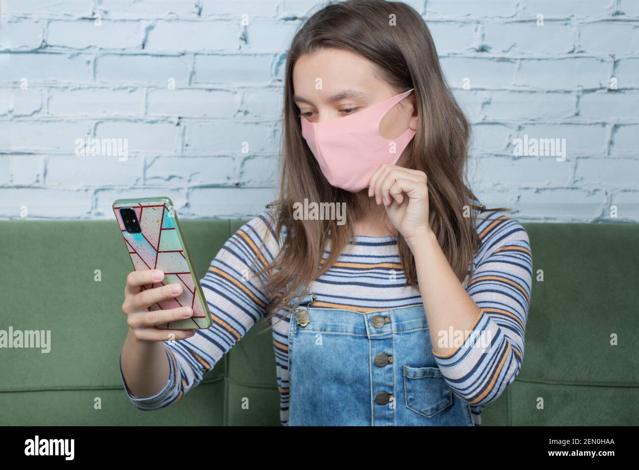 Using basic covid preventive techniques and taking selfie on the phone ...