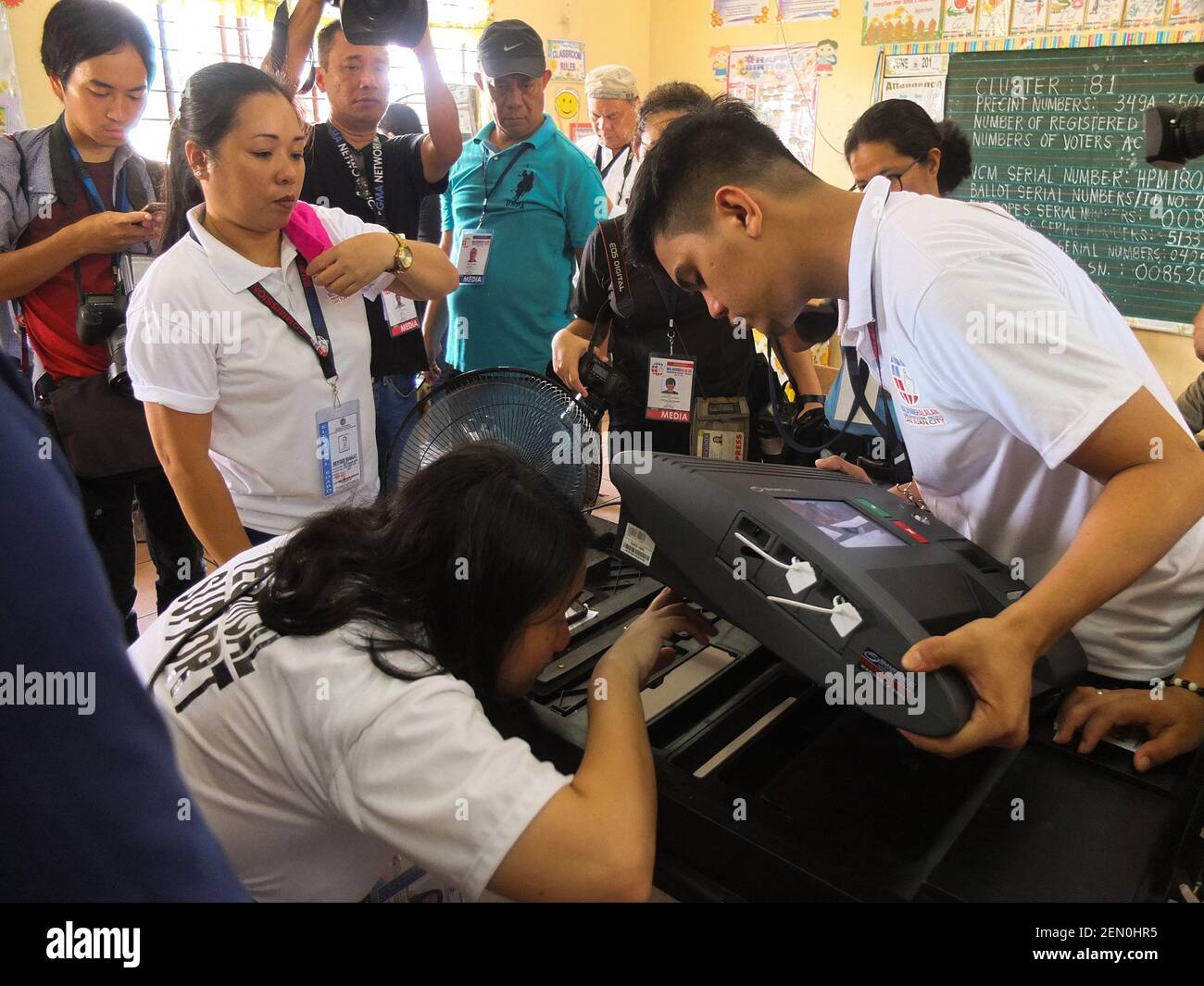 Members of the Election Board of Inspectors seen examining the new PCOS ...