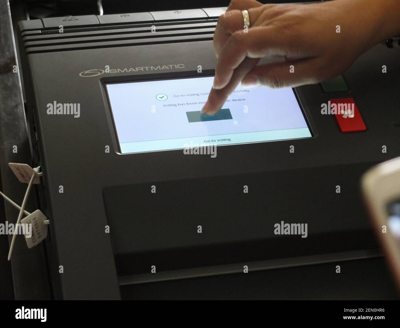 A Election board inspector seen operating the PCOS machine during the ...