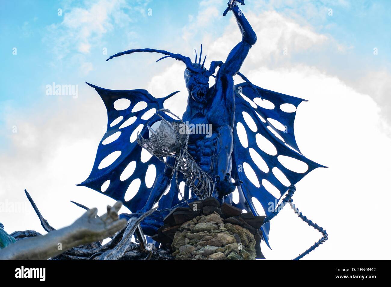 Sculpture of a metal devil on the facade of the castle, house with ...