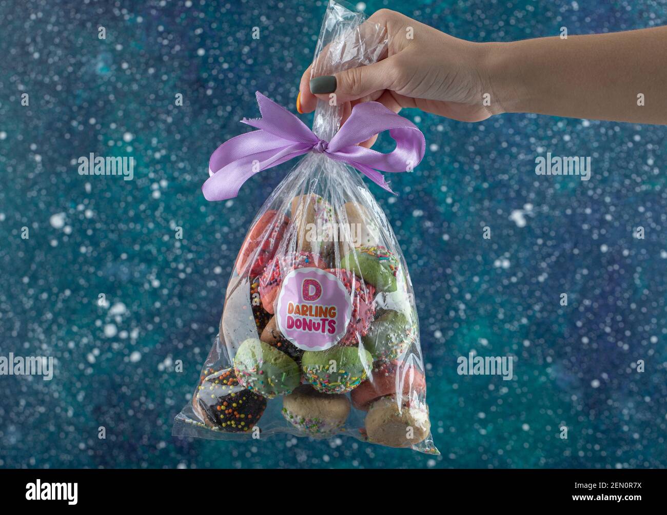 Female hand holding plastic bag of cookies Stock Photo - Alamy