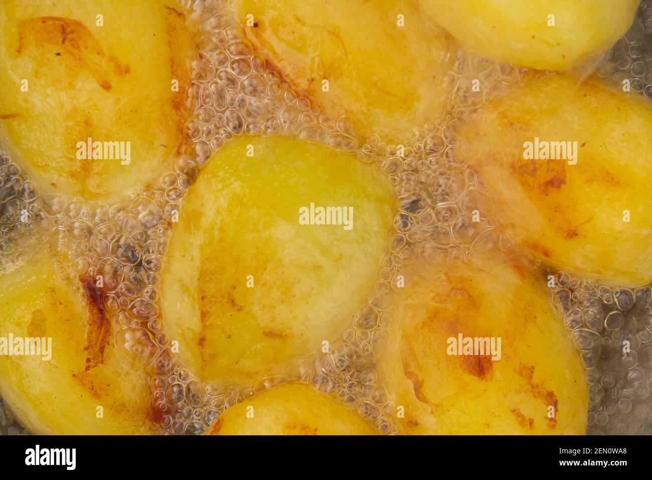 Golden potatoes are fried in boiling oil in a cauldron Stock Photo - Alamy