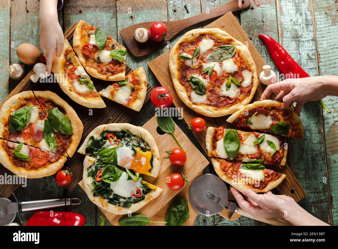 Cutted pizzas with child and woman hands overhead view Stock Photo - Alamy