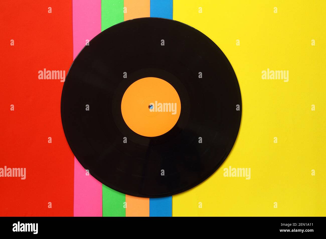 12-inch LP vinyl record disk with blank red label. Close-up shot, top ...