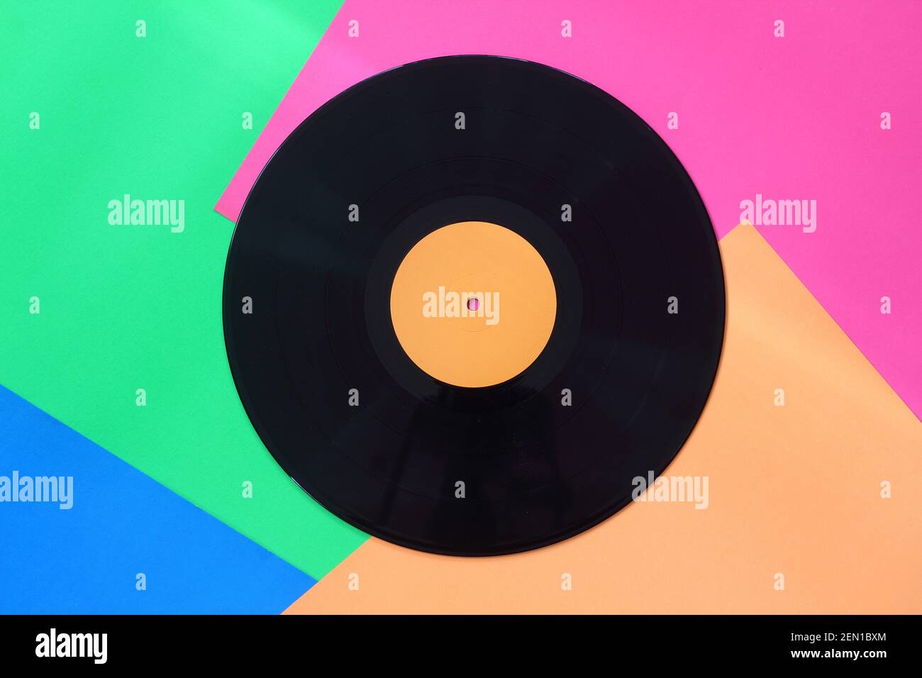 12-inch LP vinyl record disk with blank red label. Close-up shot, top ...