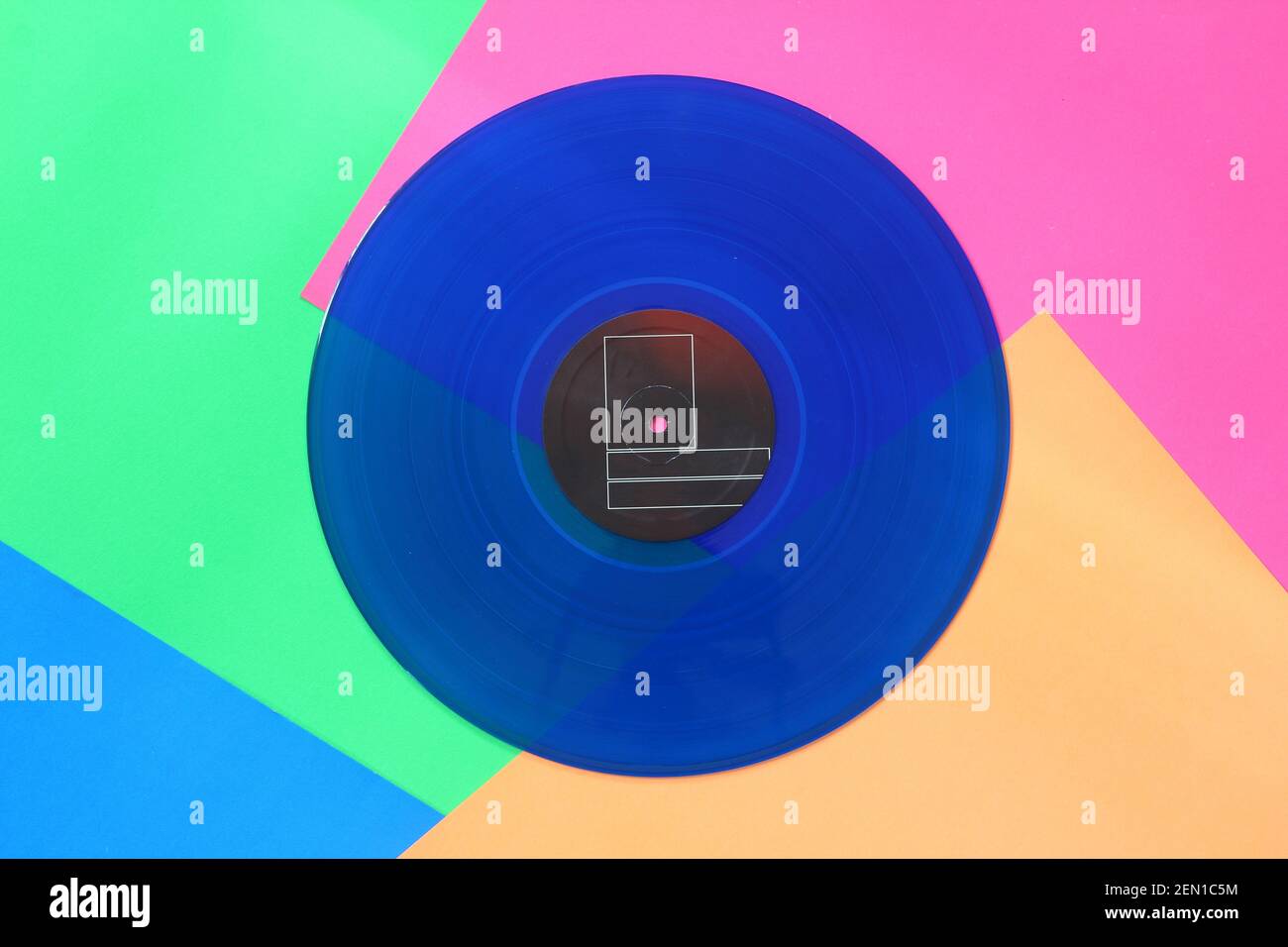 12-inch LP vinyl record disk with blank red label. Close-up shot, top ...