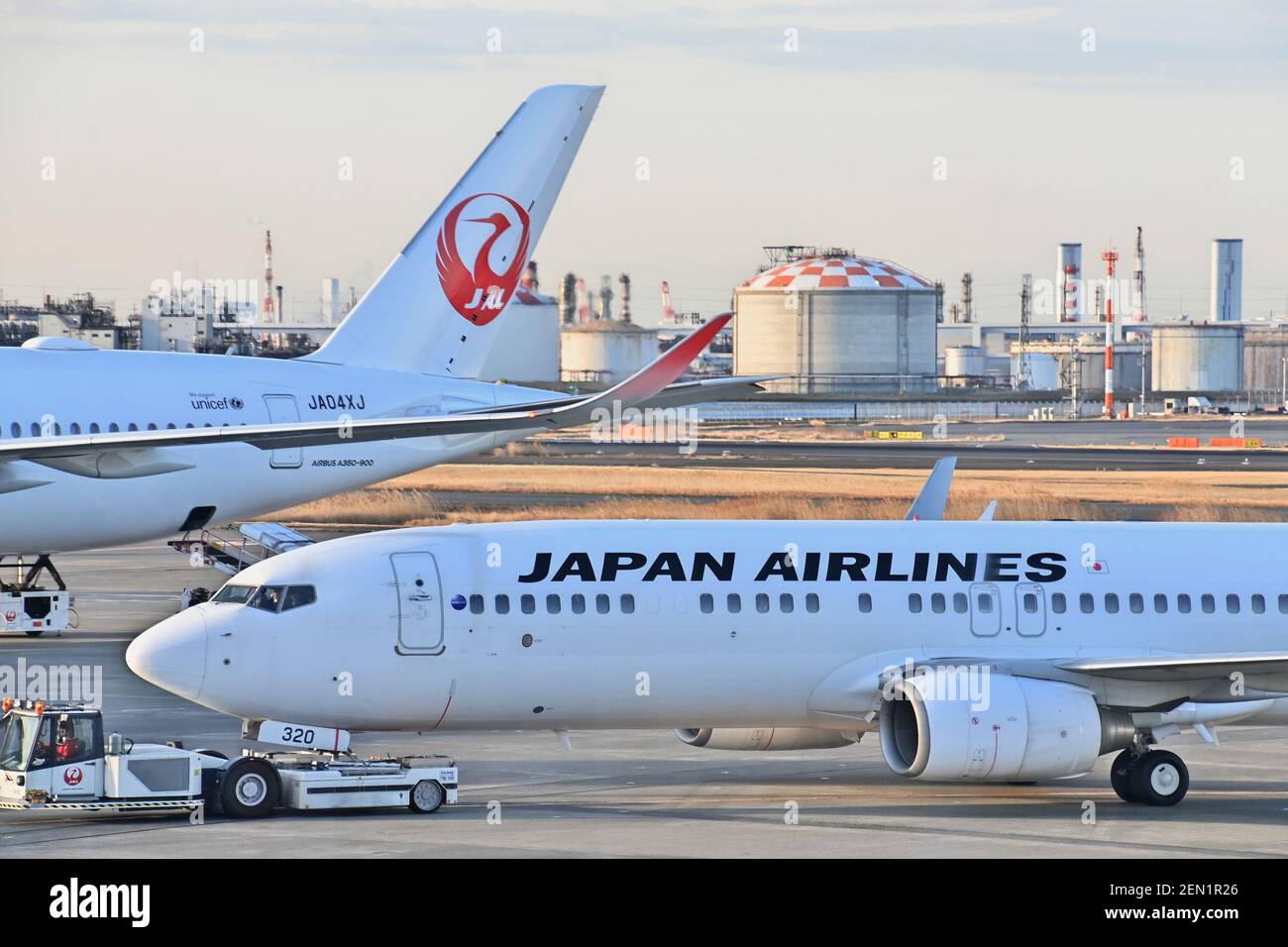 Japan Airlines (JAL) passenger aircraft are seen on the tarmac at the ...