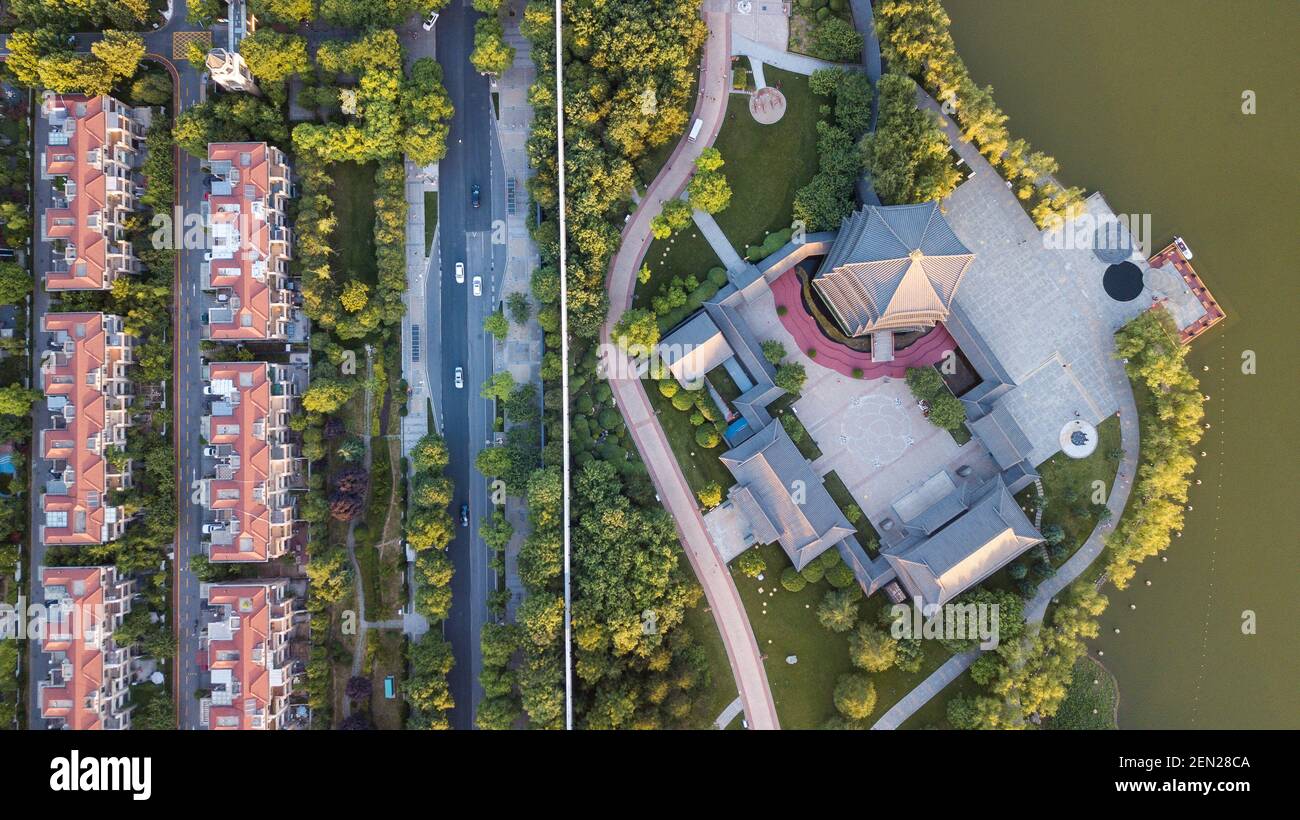 A cluster of villas with red and blue roofs along the Qujiang River in ...