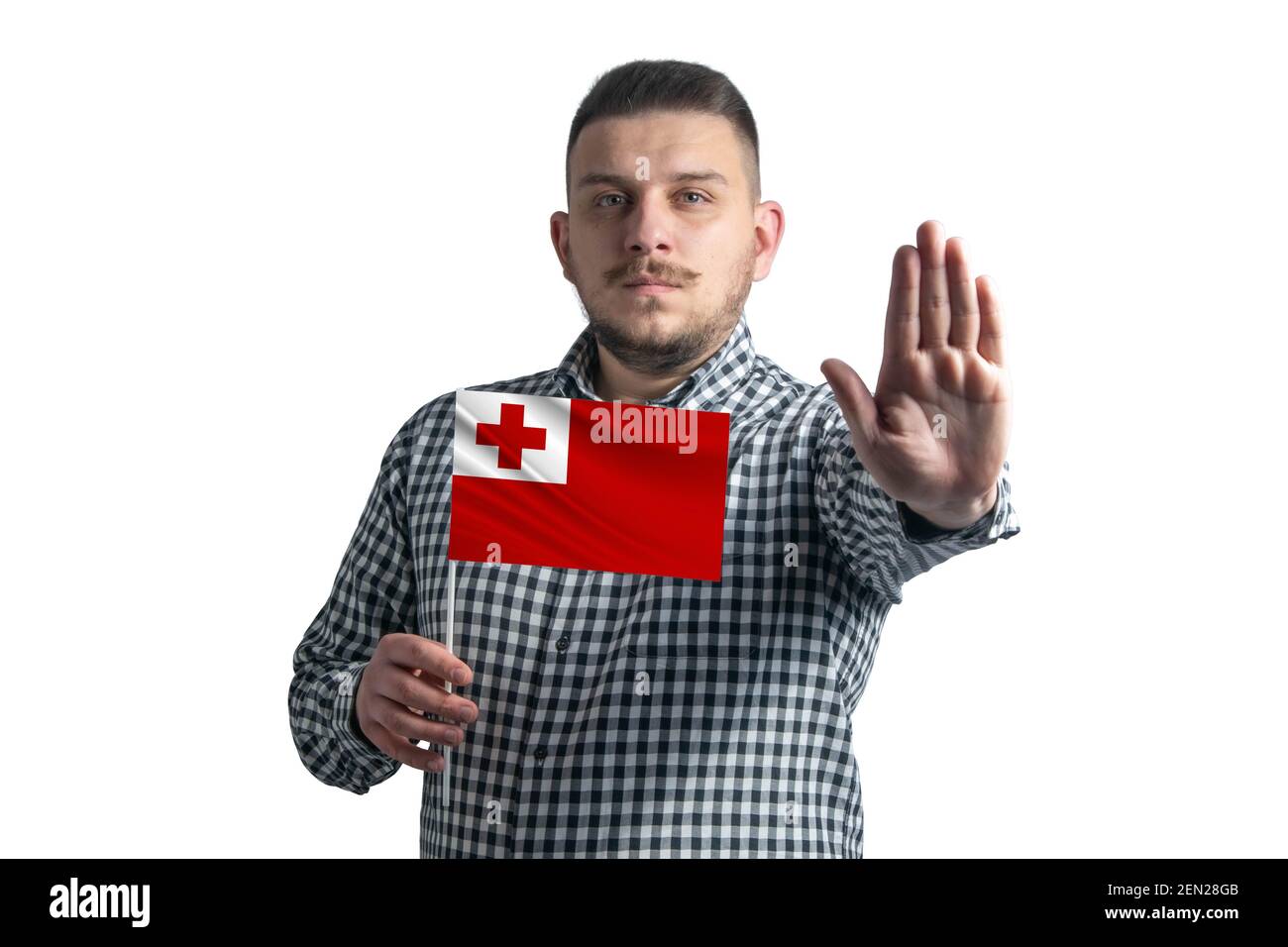 White guy holding a flag of Tonga and with a serious face shows a hand ...