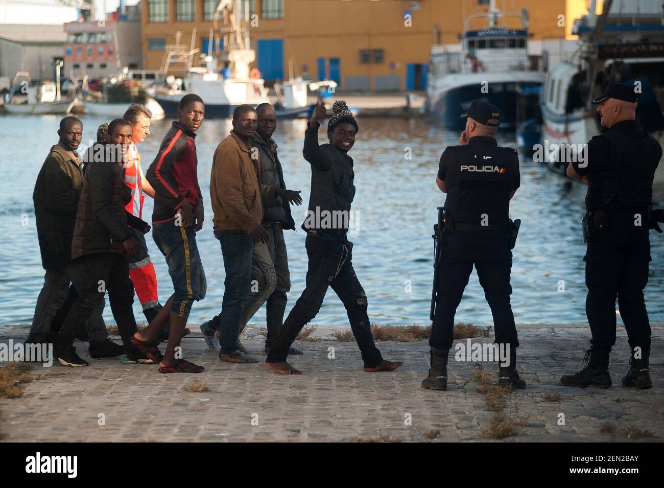 Migrants greeting in queue are seen walking to a humanitarian emergency ...