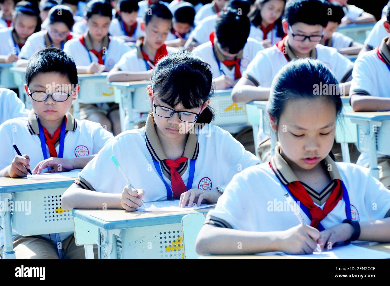 Chinese primary school students sit in rows as they practice ...