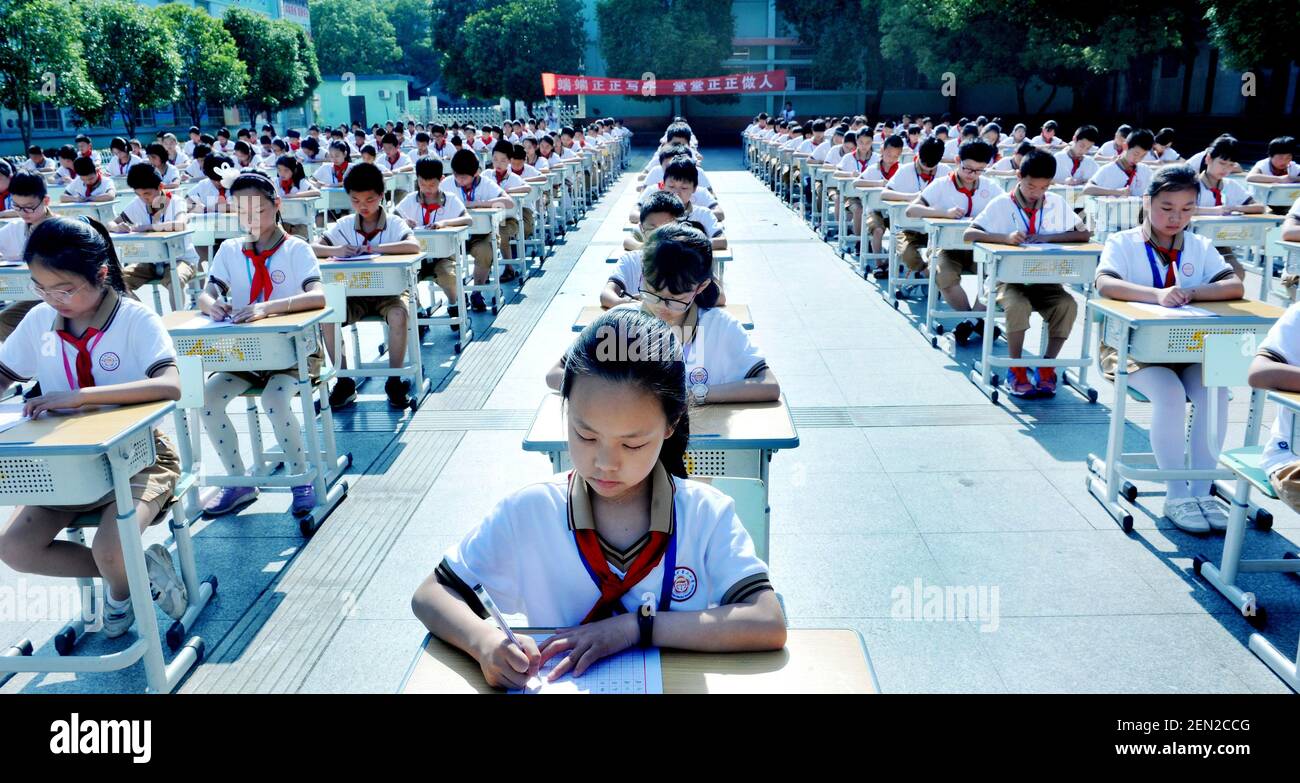 Chinese primary school students sit in rows as they practice ...