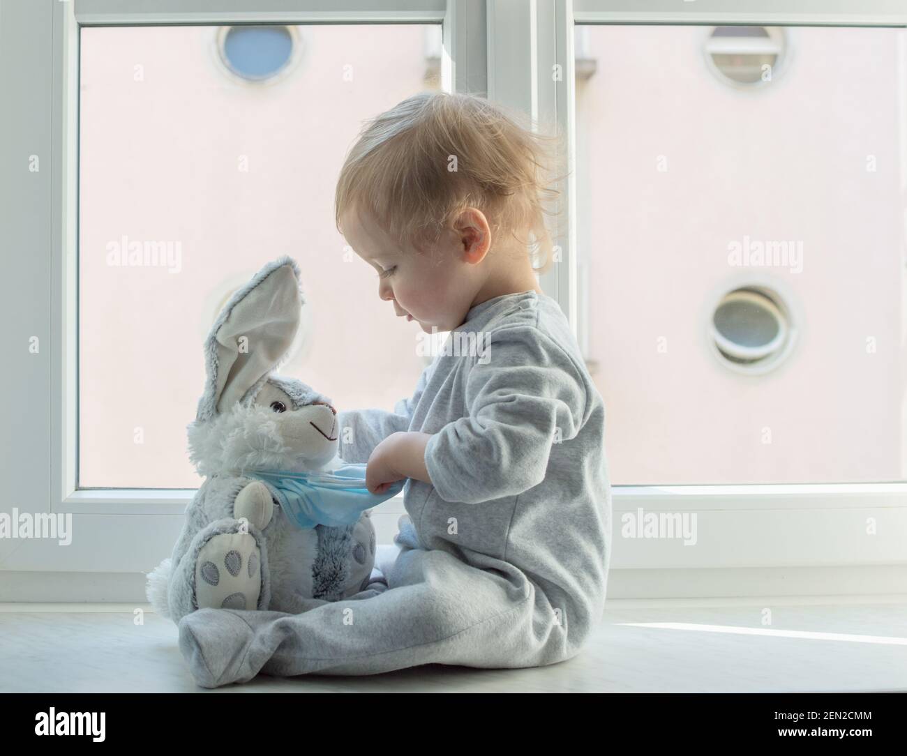 Easter 2021 concept with child in home quarantine playing at the window ...