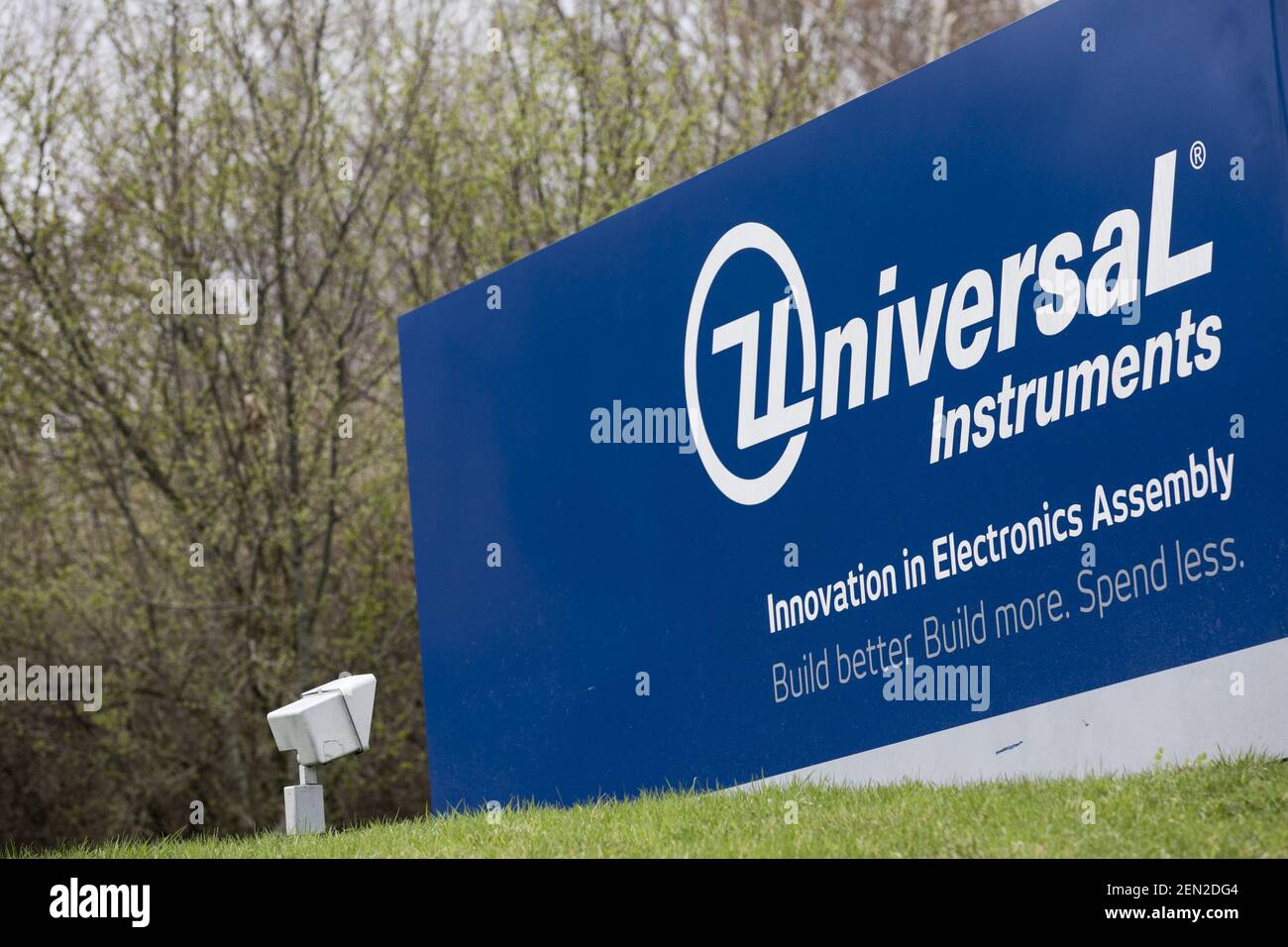 A logo sign outside of the headquarters of Universal Instruments in ...