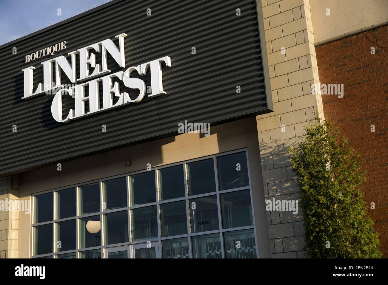 A logo sign outside of a Linen Chest retail store location in ...
