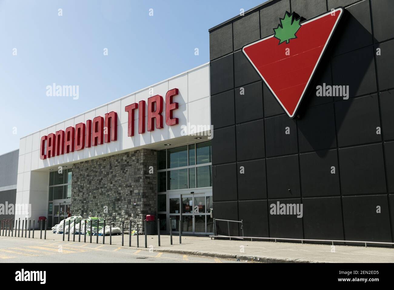 A logo sign outside of a Canadian Tire retail store location in ...