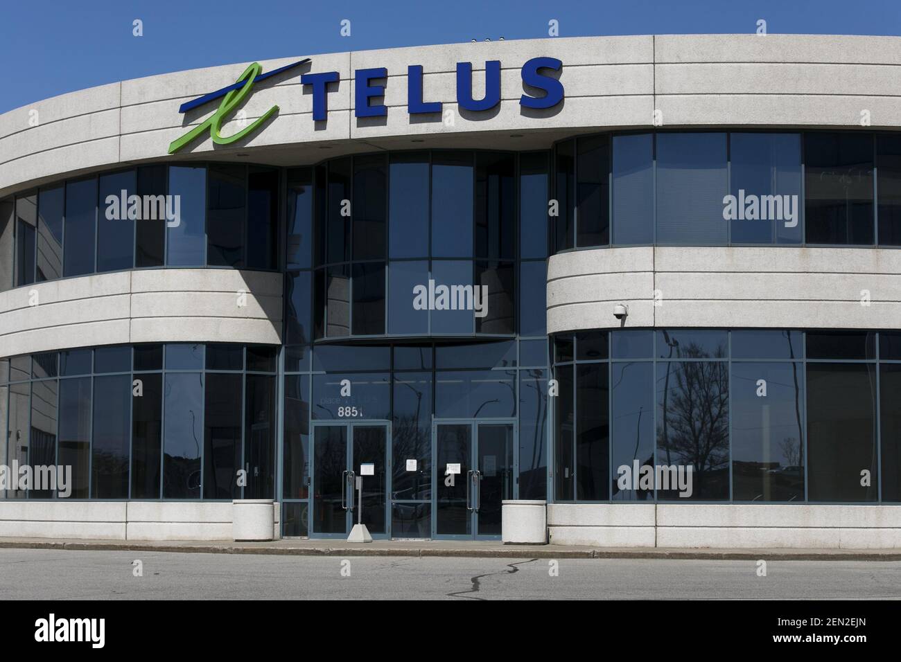 A logo sign outside of a facility occupied by the Telus Corporation in ...
