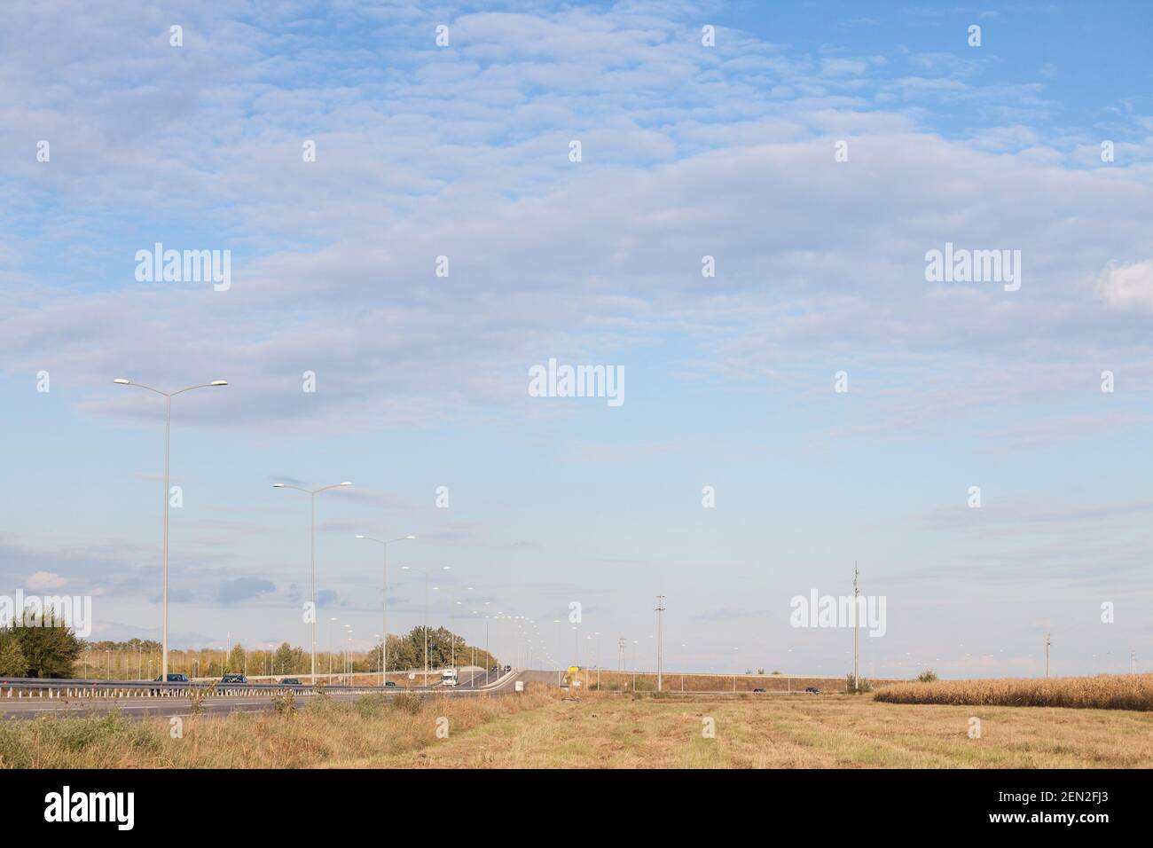 Rural landscape with a newly built freeway motorway road with traffic ...