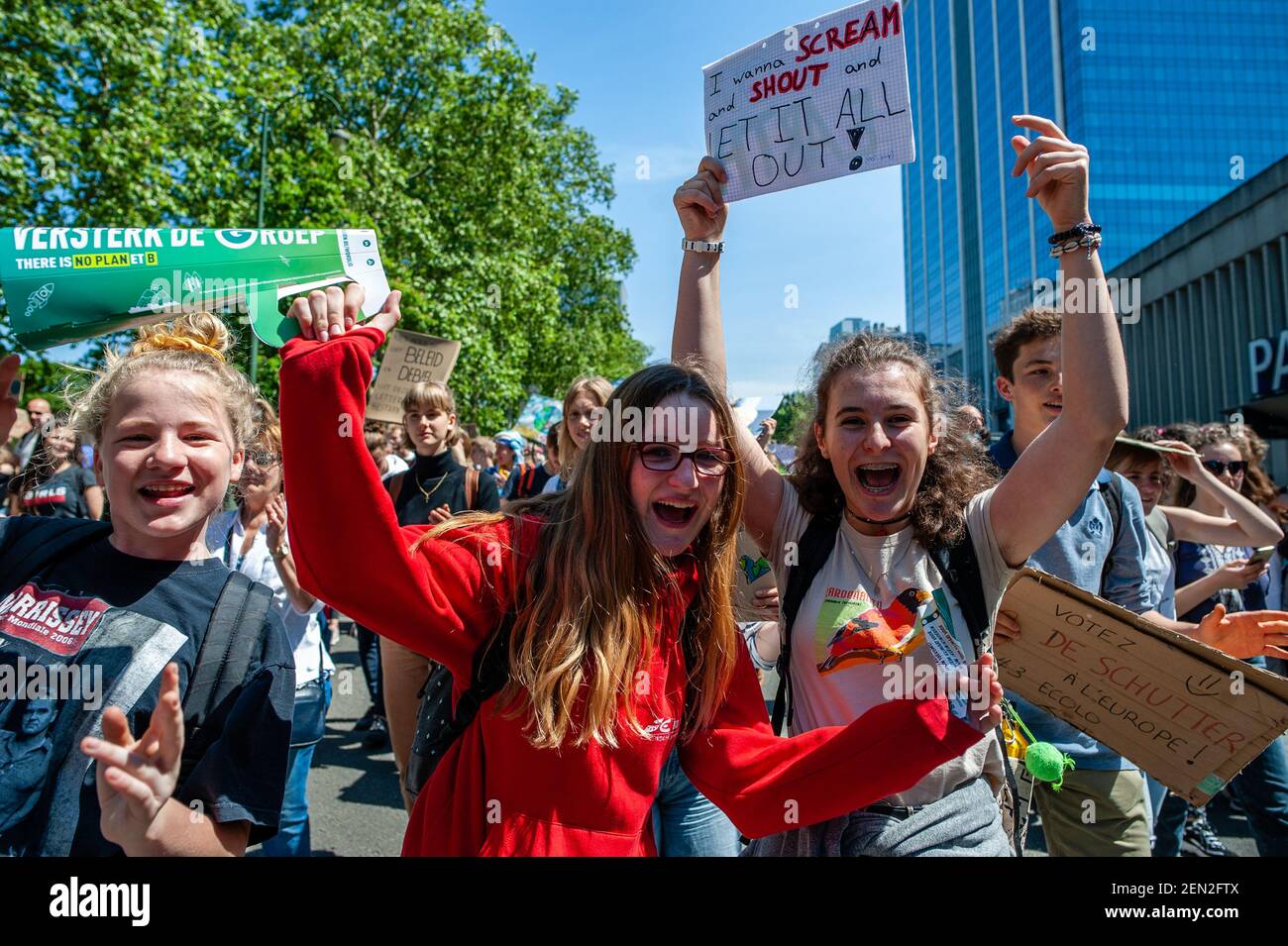 Two girls are seen holding placards shouting slogans during the protest ...