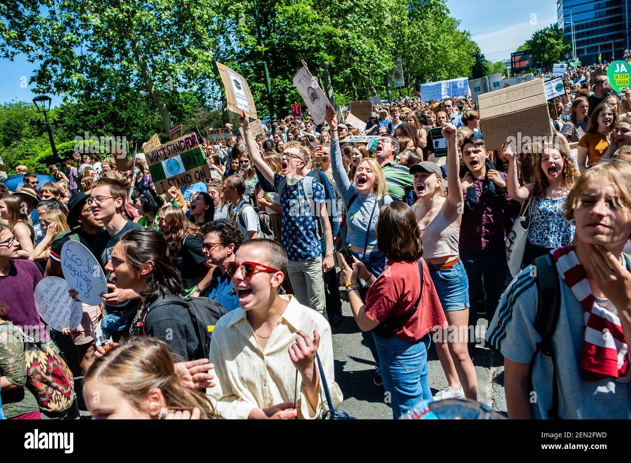 A group of people are seen shouting slogans while walking during the ...