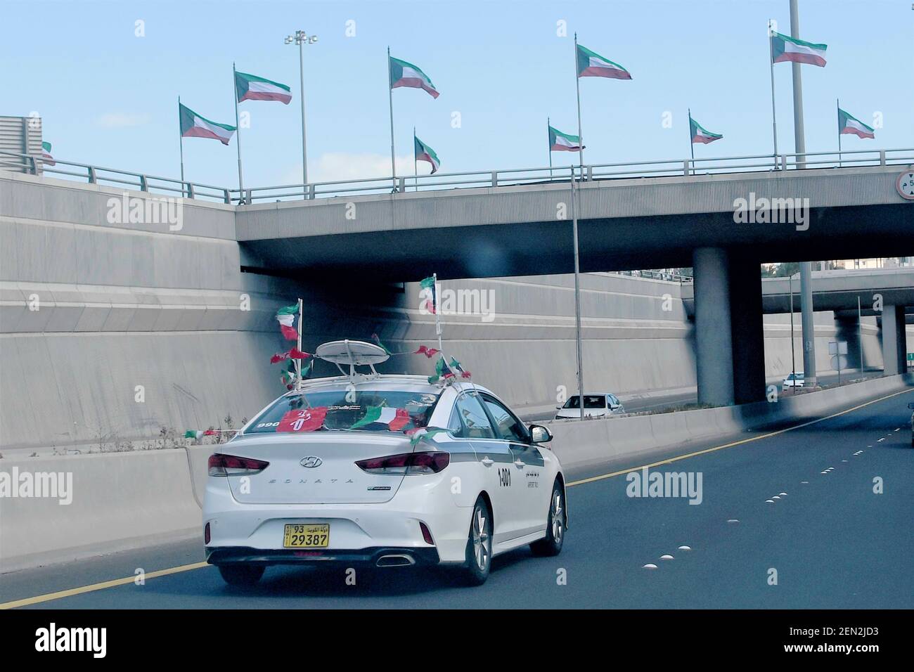 Kuwait City, Kuwait. 25th Feb, 2021. A car decorated with flags runs on ...