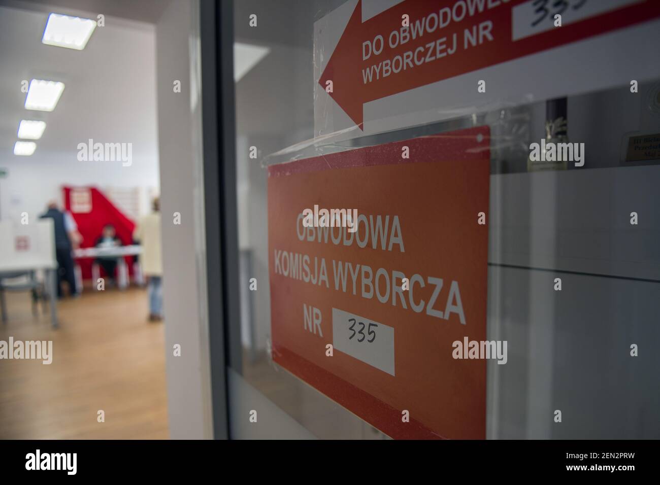 A poster showing the direction to the entrance of the polling station ...