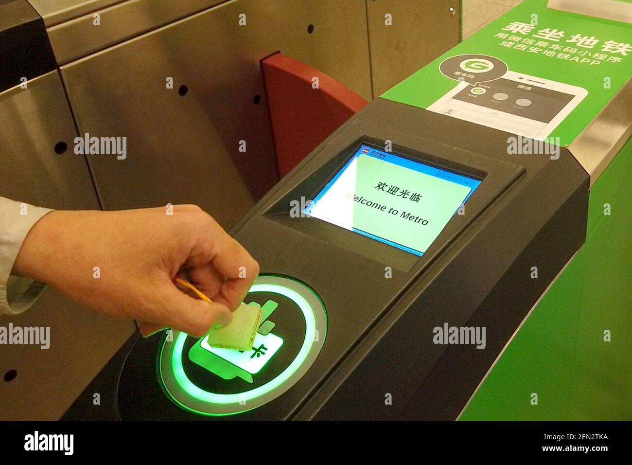 A passenger swipes his Chang'an Tong public transport card featuring ...