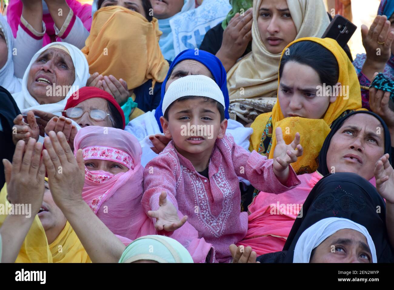 A Kashmiri Muslim boy seen raising their hands to seek for blessings as ...