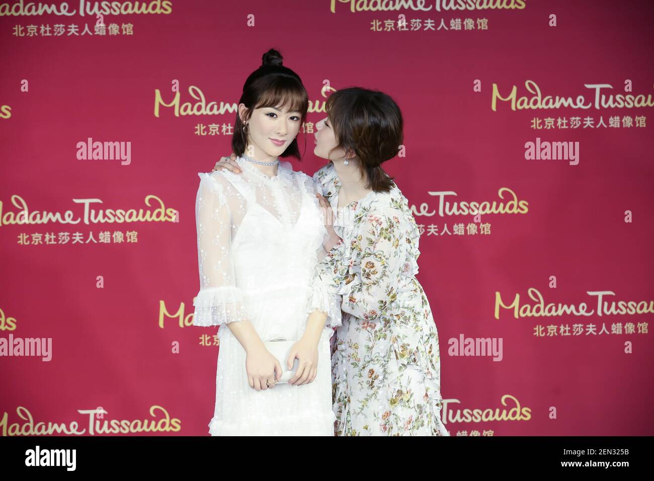 Chinese actress Andy Yang or Yang Zi looks at the wax figure of her ...