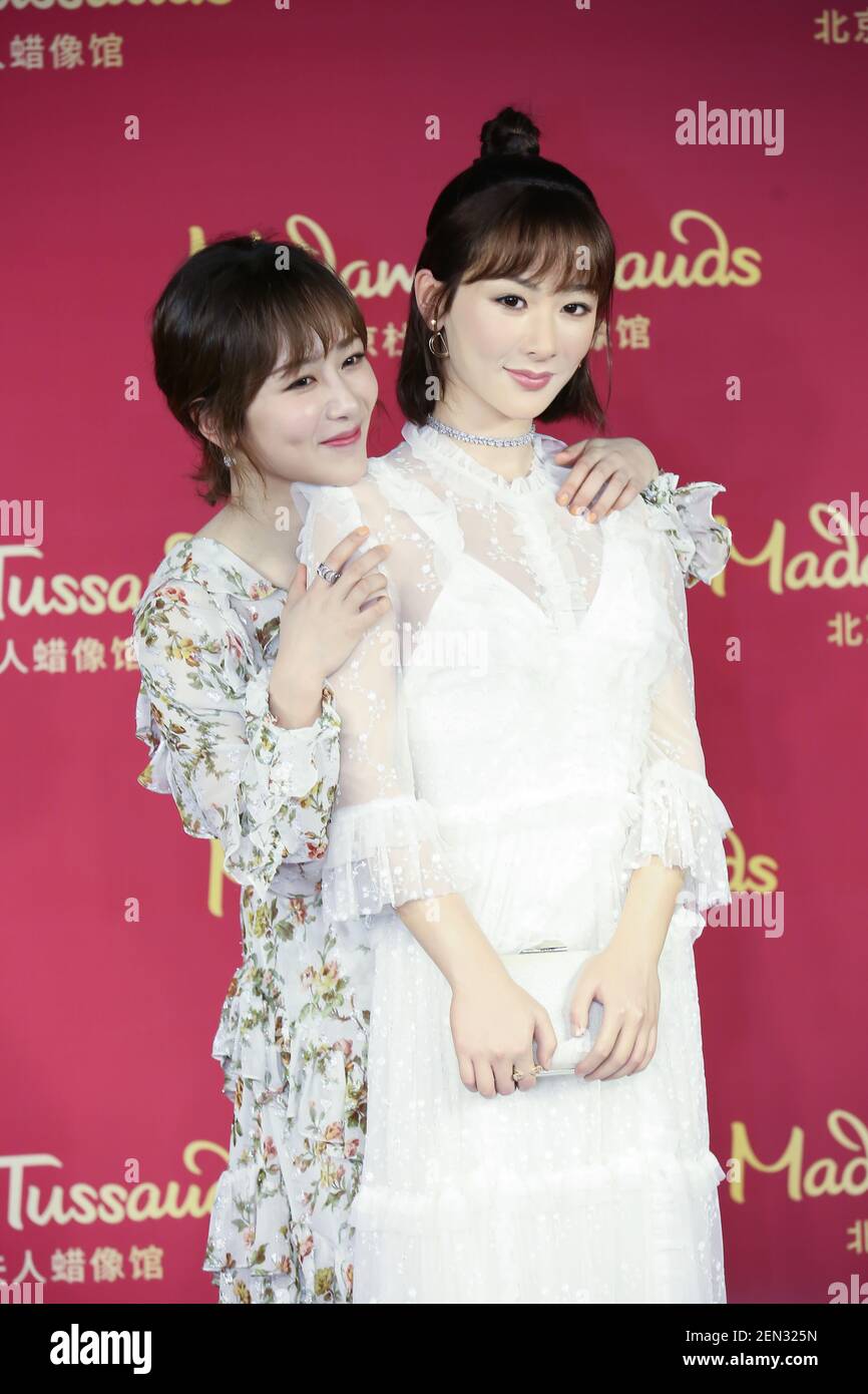 Chinese actress Andy Yang or Yang Zi poses with the wax figure of her ...