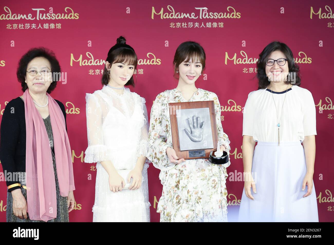 Chinese actress Andy Yang or Yang Zi, second right, poses with the wax ...