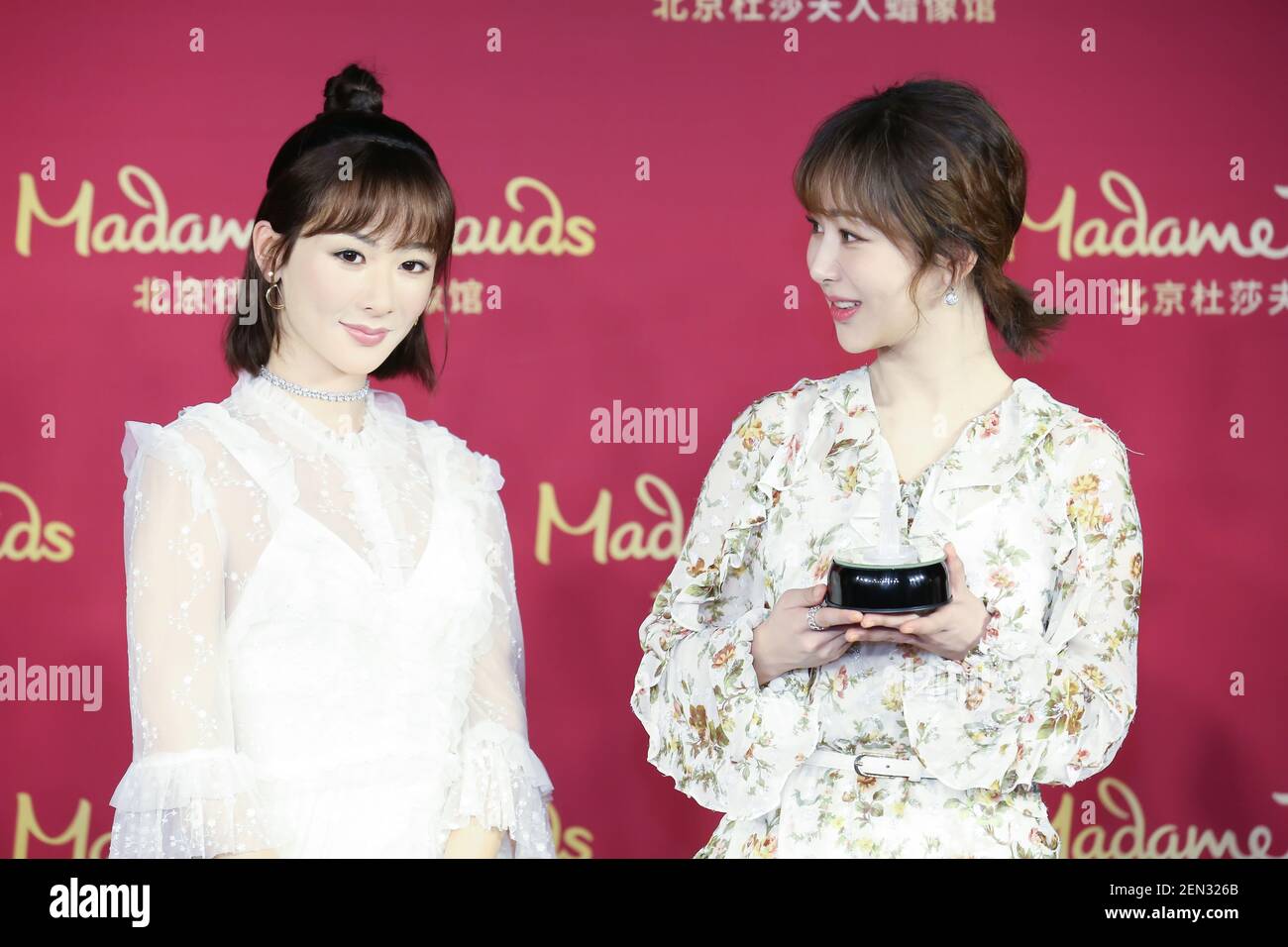 Chinese actress Andy Yang or Yang Zi looks at the wax figure of her ...