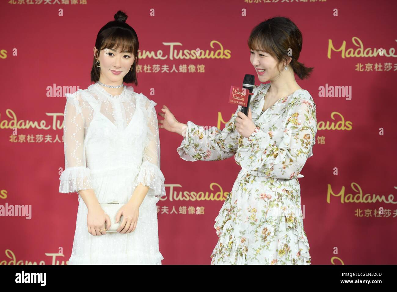 Chinese actress Andy Yang or Yang Zi looks at the wax figure of her during an unveiling ceremony ...