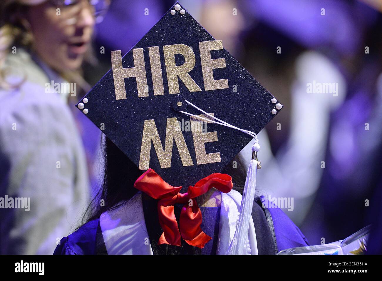 Graduating students wear custom decorated graduation caps as they ...