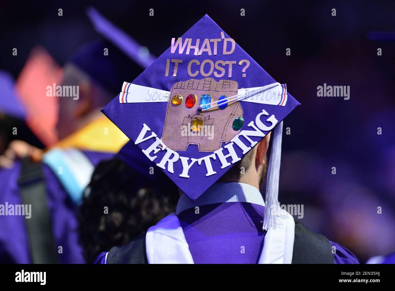Graduating students wear custom decorated graduation caps as they ...