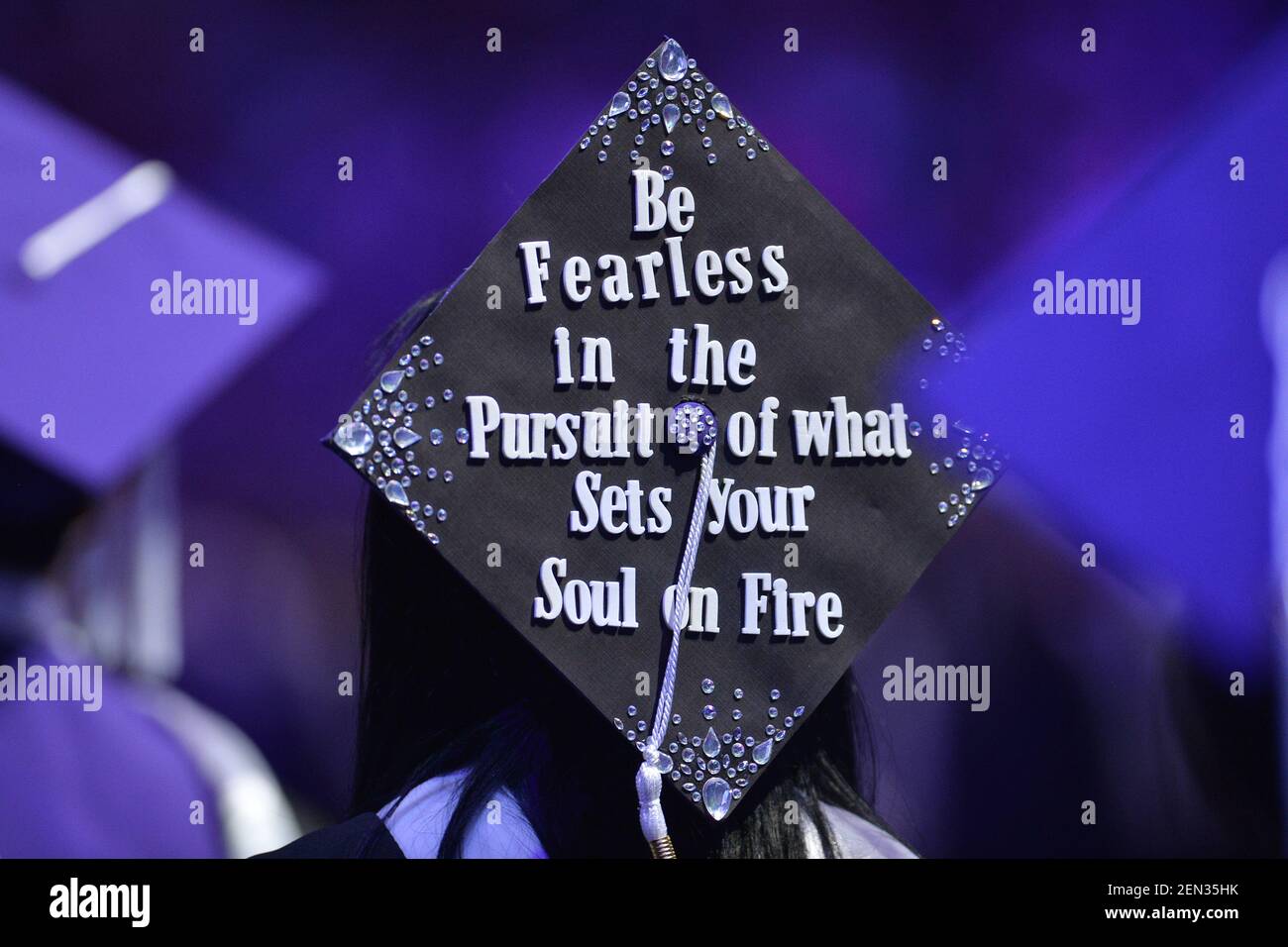 Graduating students wear custom decorated graduation caps as they ...