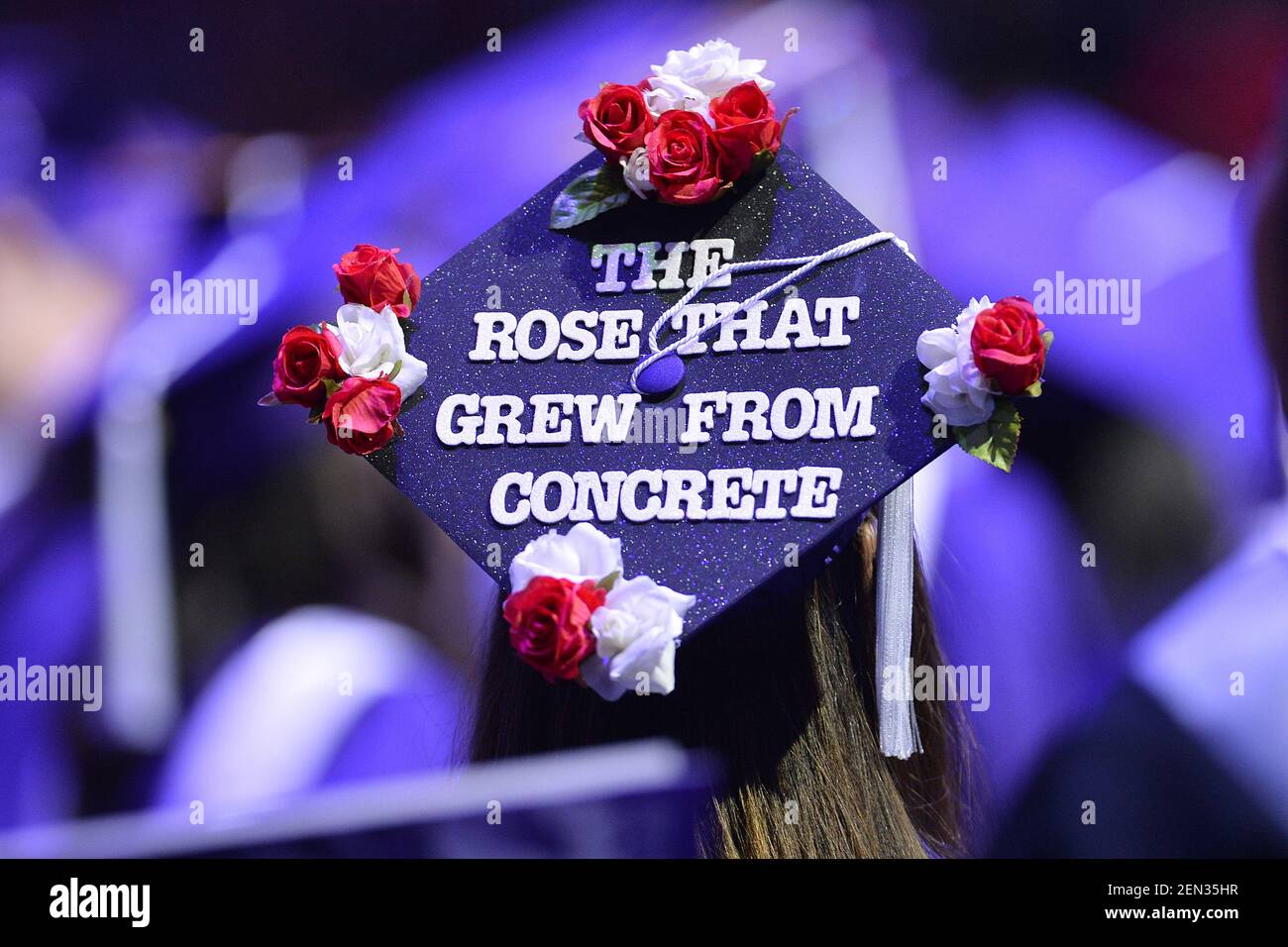 Graduating students wear custom decorated graduation caps as they ...