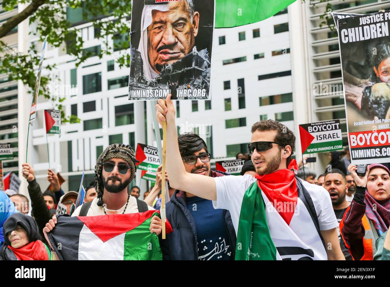 Protesters hold placards and Palestinian flag during the rally. The Al ...