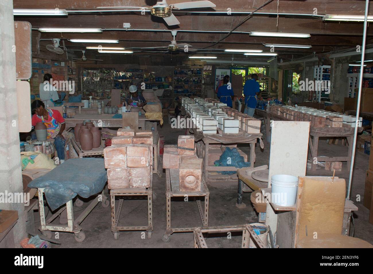 Caribbean pottery factory with skilled artisan workers. Tables and ...