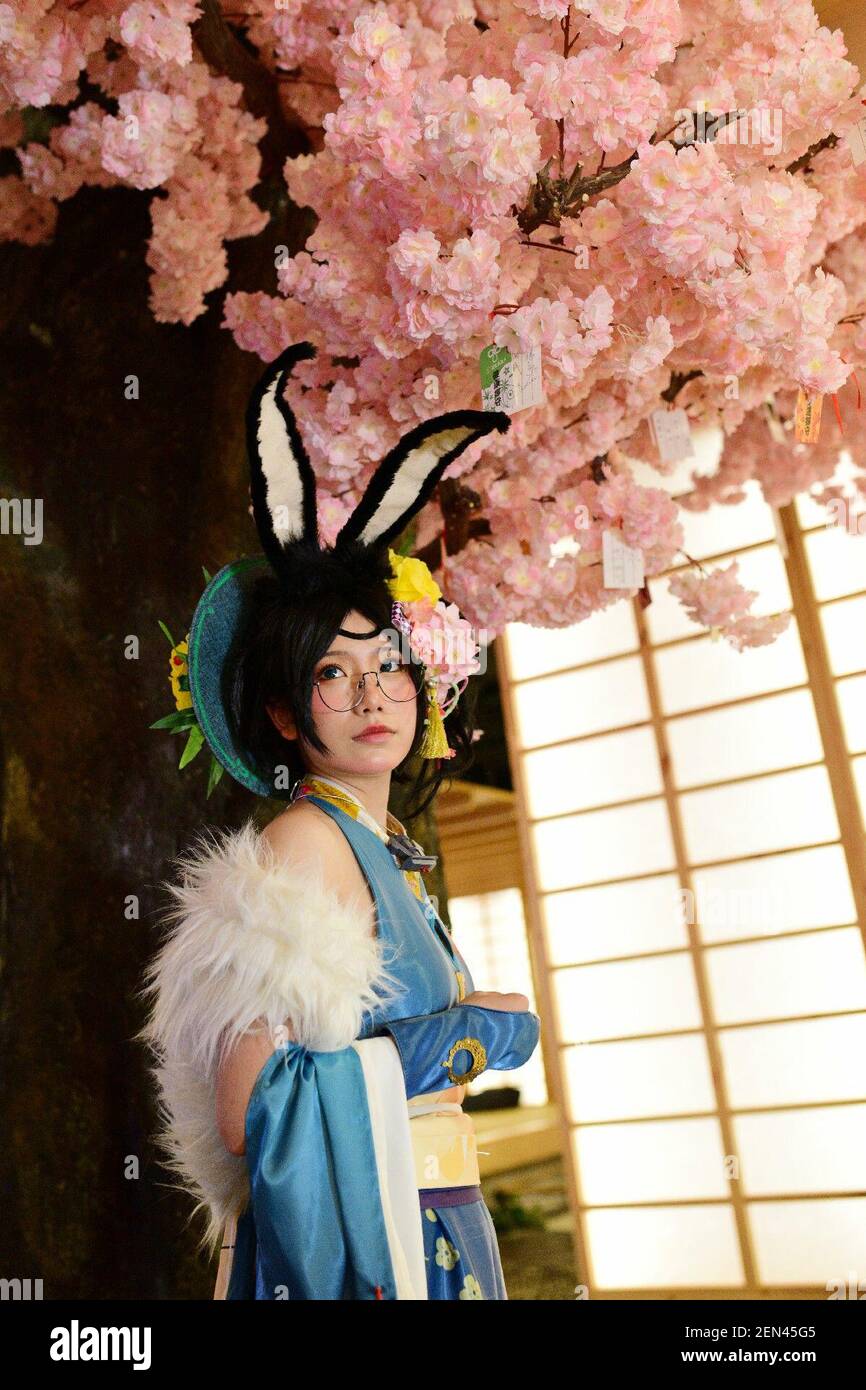 An entertainer dressed in cosplay costume featuring characters of side ...