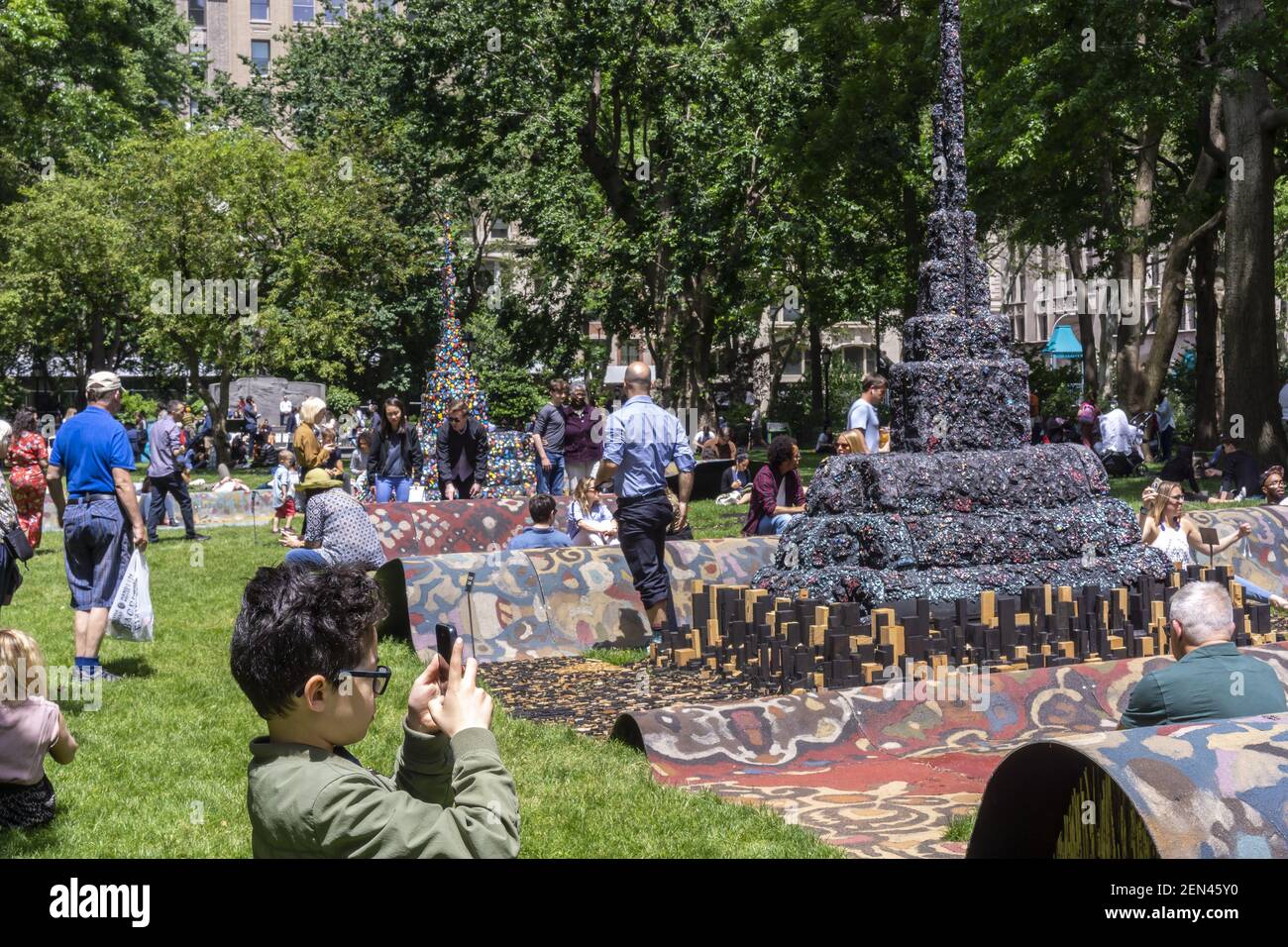 Visitors to Madison Square Park enjoy the warm weather by lounging on ...
