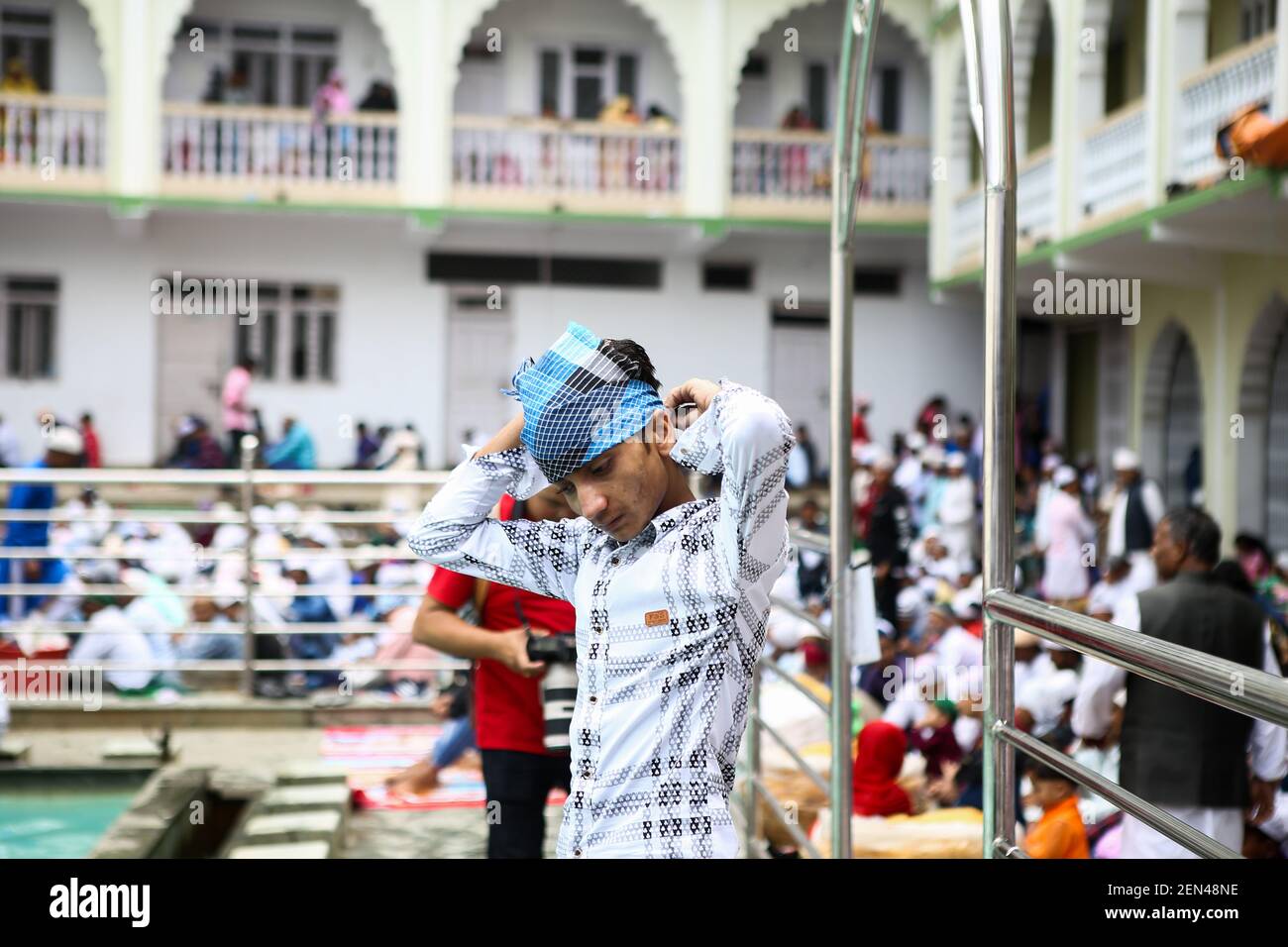 A Muslim man prepares to perform Eid al-Fitr prayers at Kashmiri Jame ...