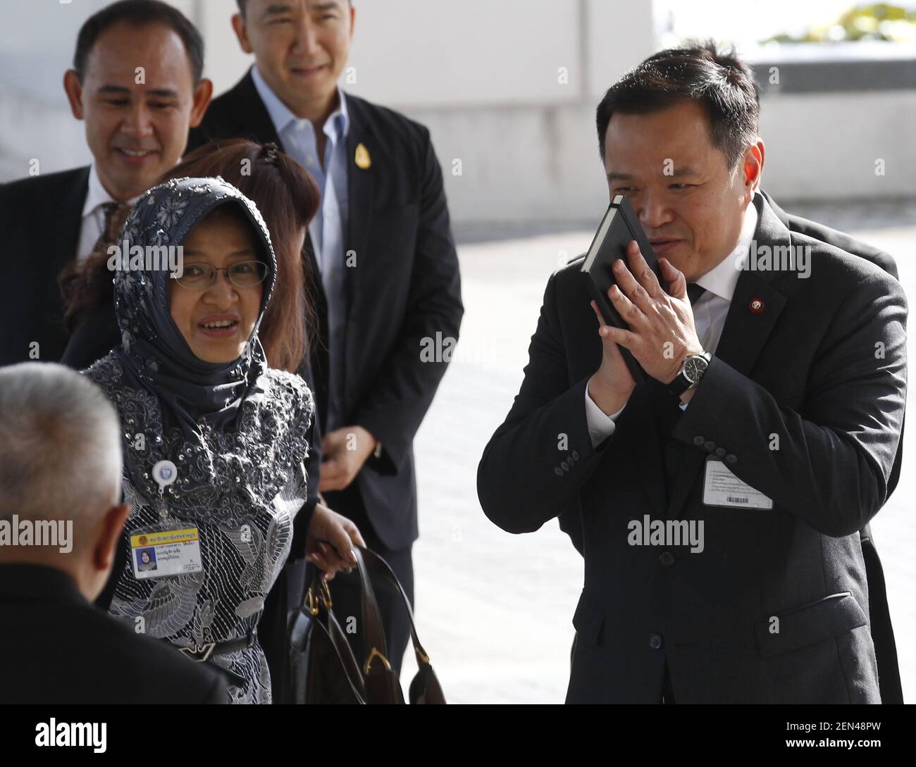 Bhumjaithai Party leader Anutin Charnvirakul (R) makes a gesture on arriving to the parliament ...