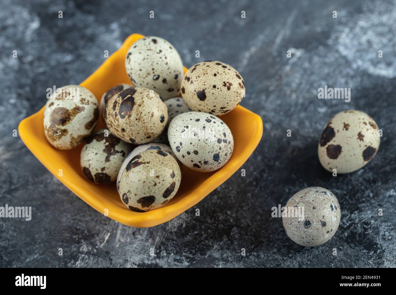 Organic farm quail egg in yellow bowl Stock Photo - Alamy