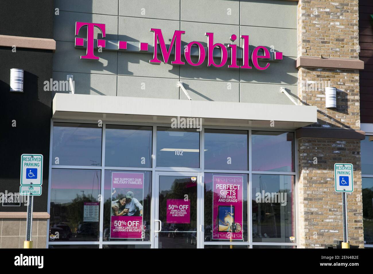 A logo sign outside of a T-Mobile retail store location in Martinsburg ...