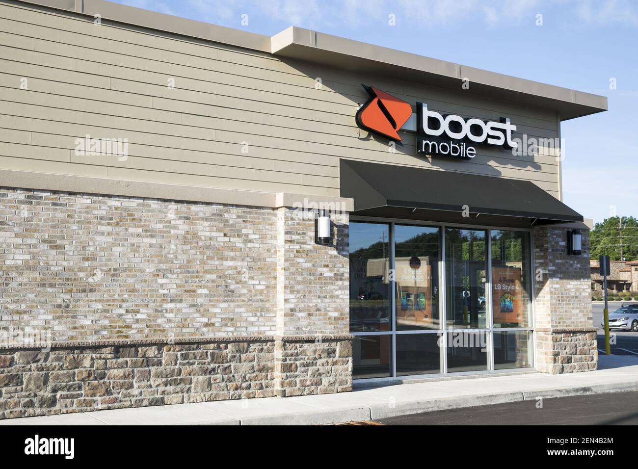 A logo sign outside of a Boost Mobile retail store location in ...