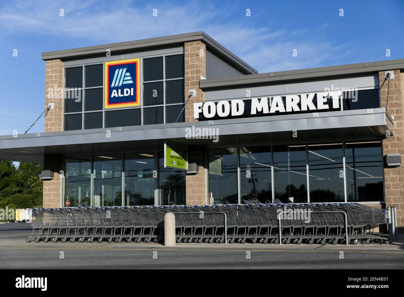 A logo sign outside of a Aldi retail grocery store location in ...