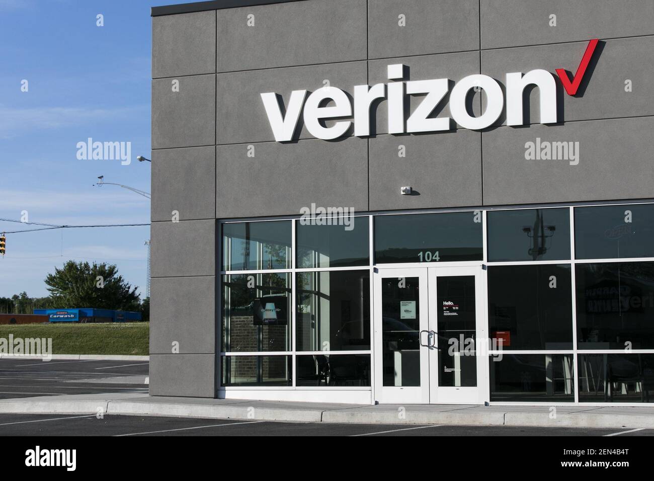 A logo sign outside of a Verizon Wireless retail store location in ...